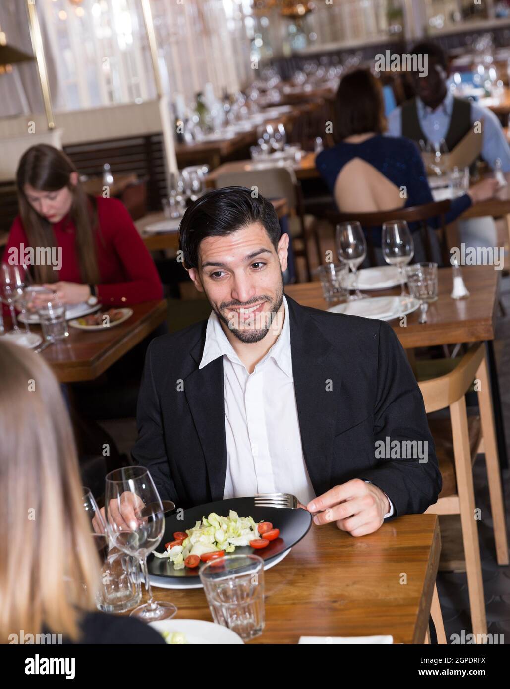 Girl sitting in restaurant eating hi-res stock photography and images ...