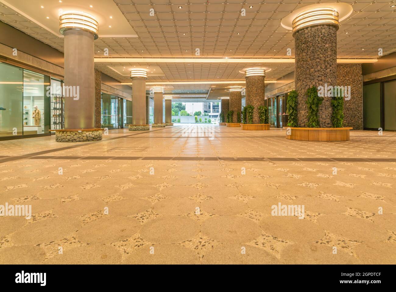 Empty ground floor of a modern building with lights Stock Photo - Alamy