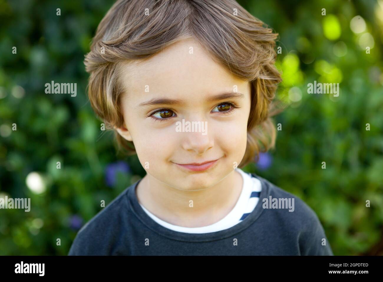 Adorable small child in the field looking at camera Stock Photo - Alamy