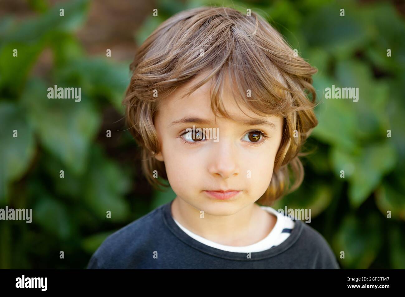Adorable small child in the field looking at camera Stock Photo - Alamy