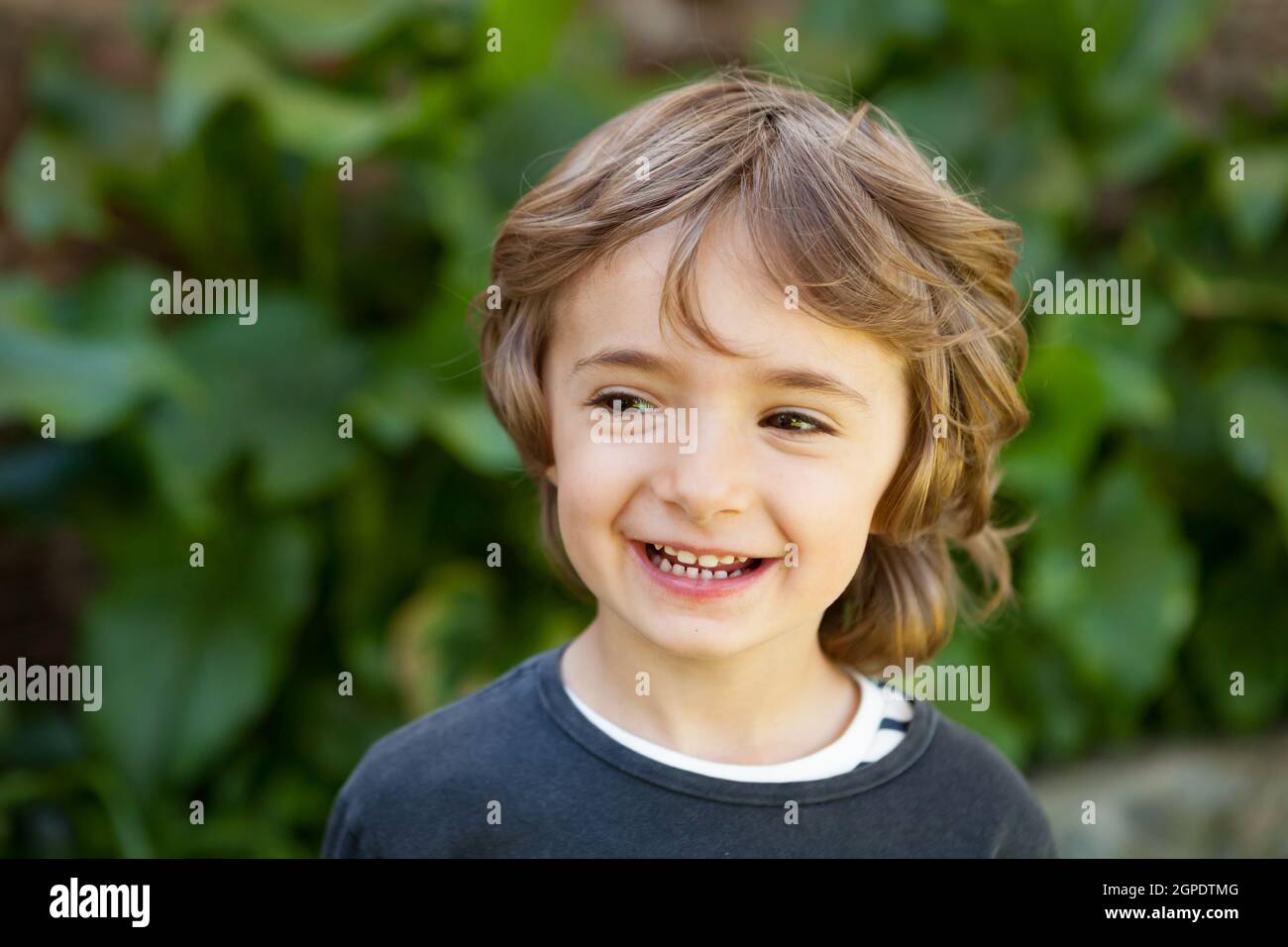 Adorable small child in the field looking at camera Stock Photo - Alamy