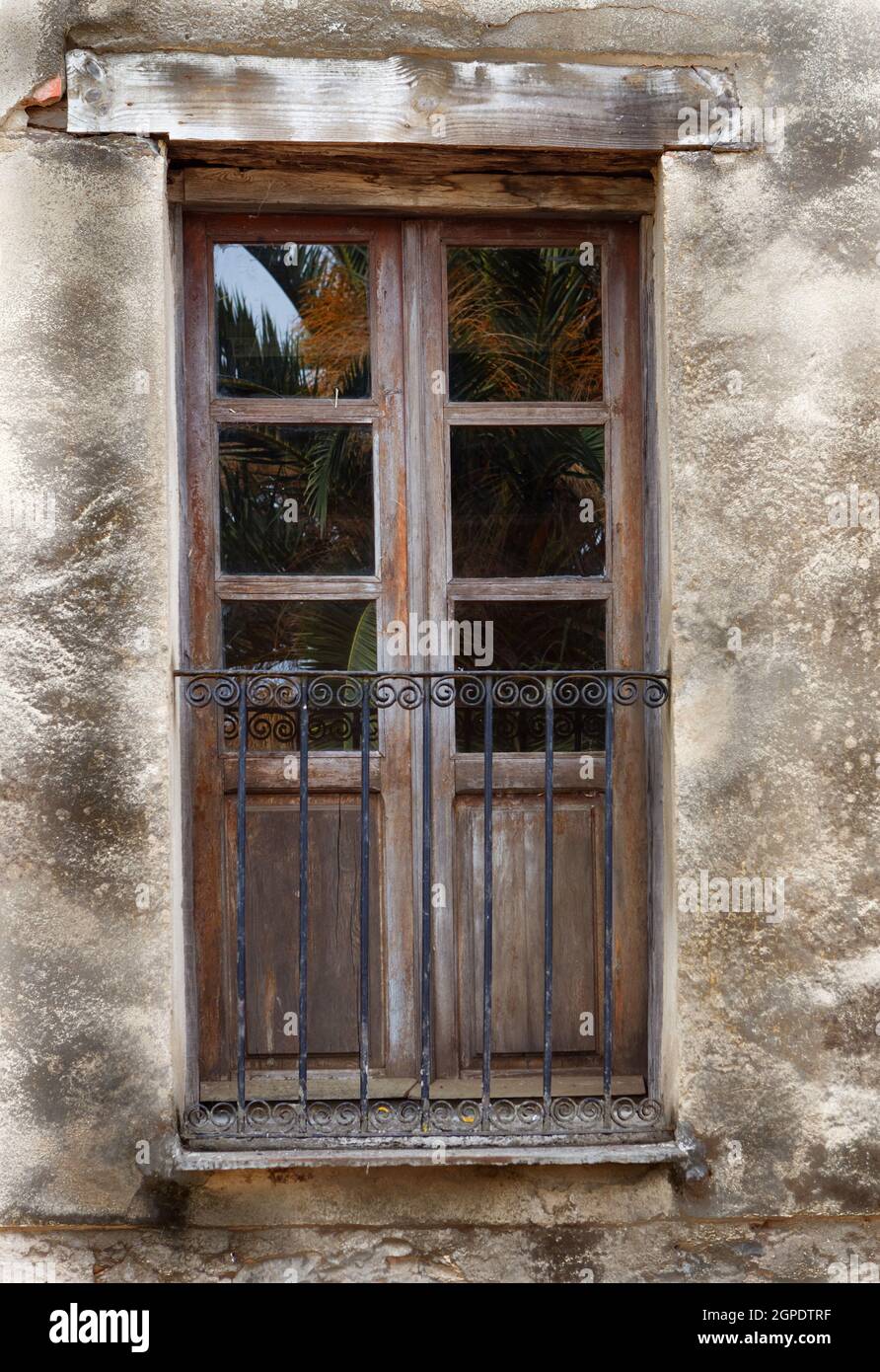 Old brown door of a balcony with iron railing Stock Photo - Alamy