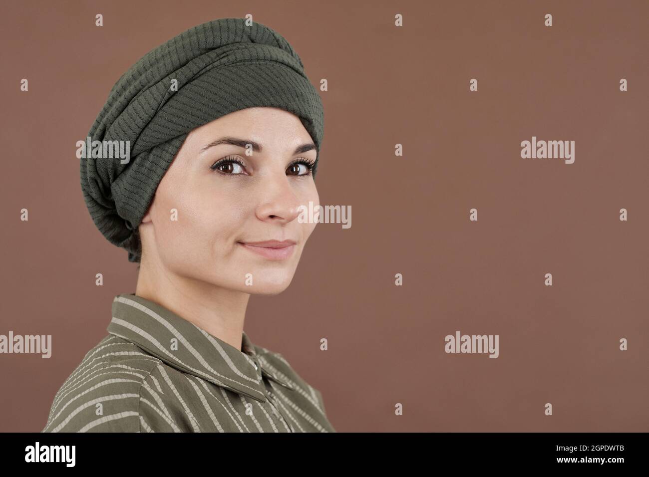 Horizontal close-up studio portrait of beautiful Muslim woman wearing ...