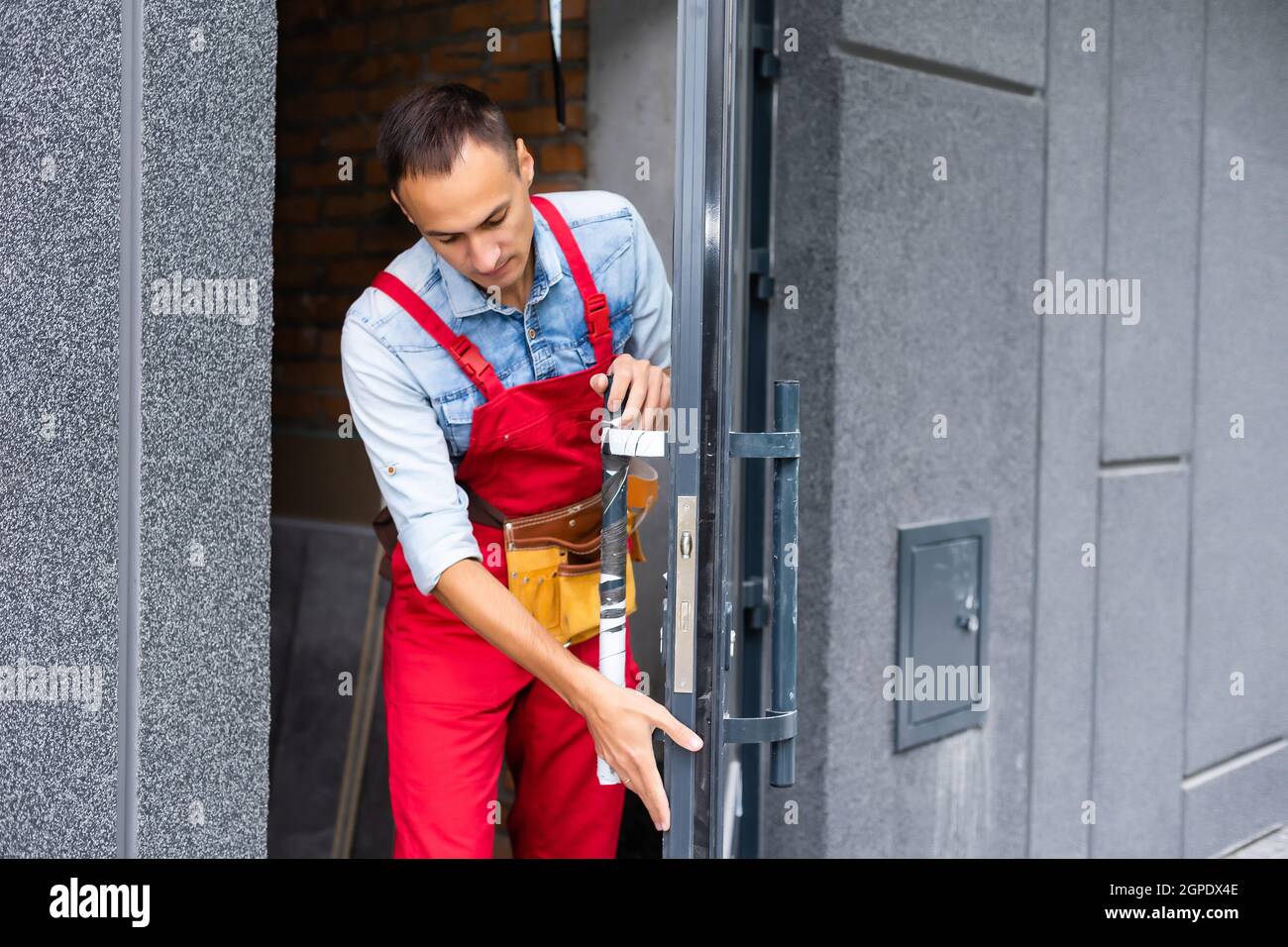 Man installing a door. renovation in a renovated building Stock Photo ...