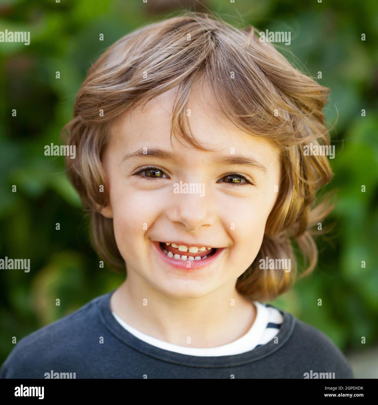 Adorable small child in the field looking at camera Stock Photo - Alamy