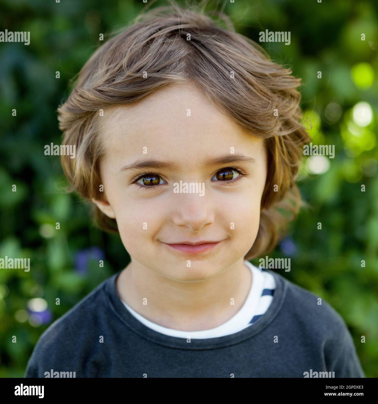 Adorable small child in the field looking at camera Stock Photo - Alamy