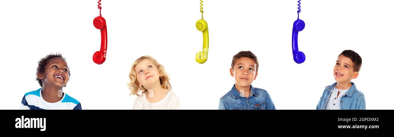 Pensive children looking at coloured hanged phones isolated on a white ...
