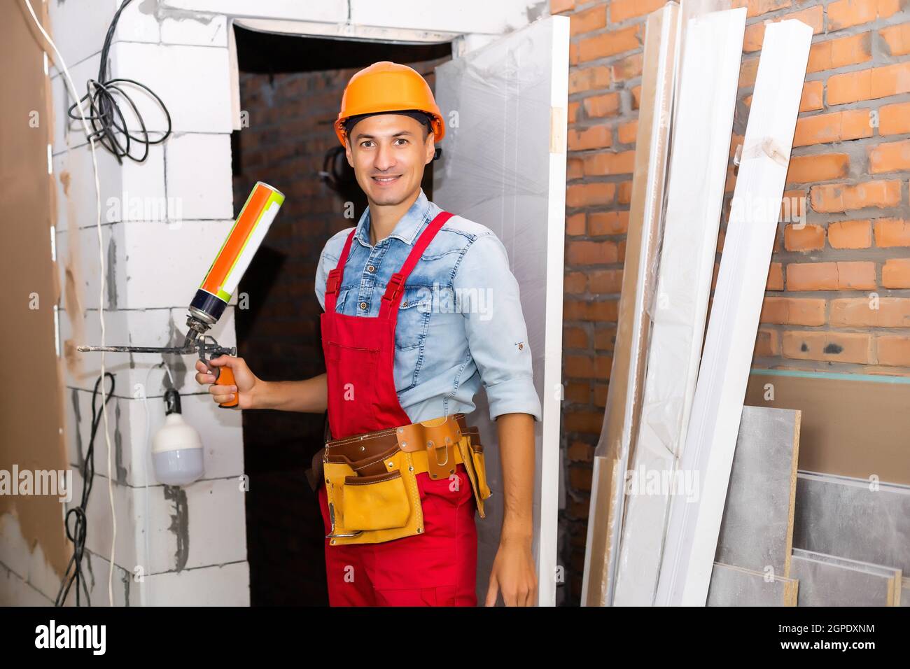 Young male worker or builder in building being renovated Stock Photo ...