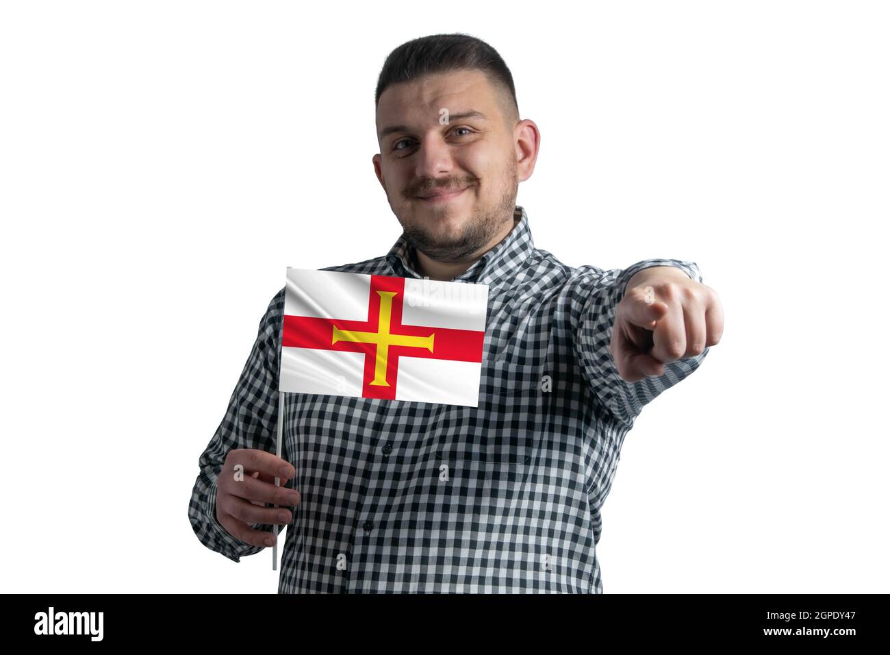 White guy holding a flag of Guernsey and points forward in front of him ...