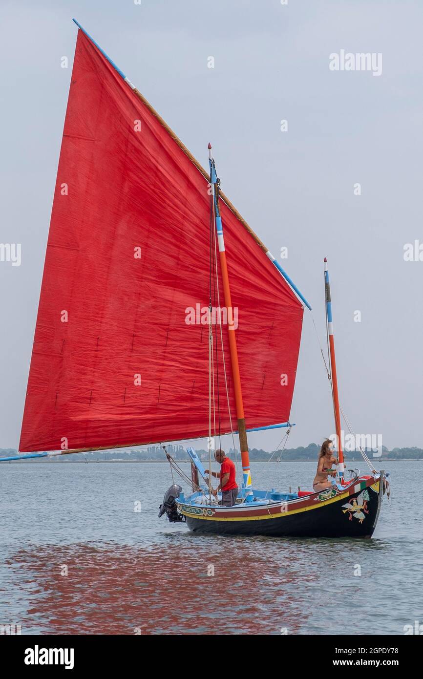 VENICE, ITALY - JUNE 20: Red regatta participants sail in the lagoon ...
