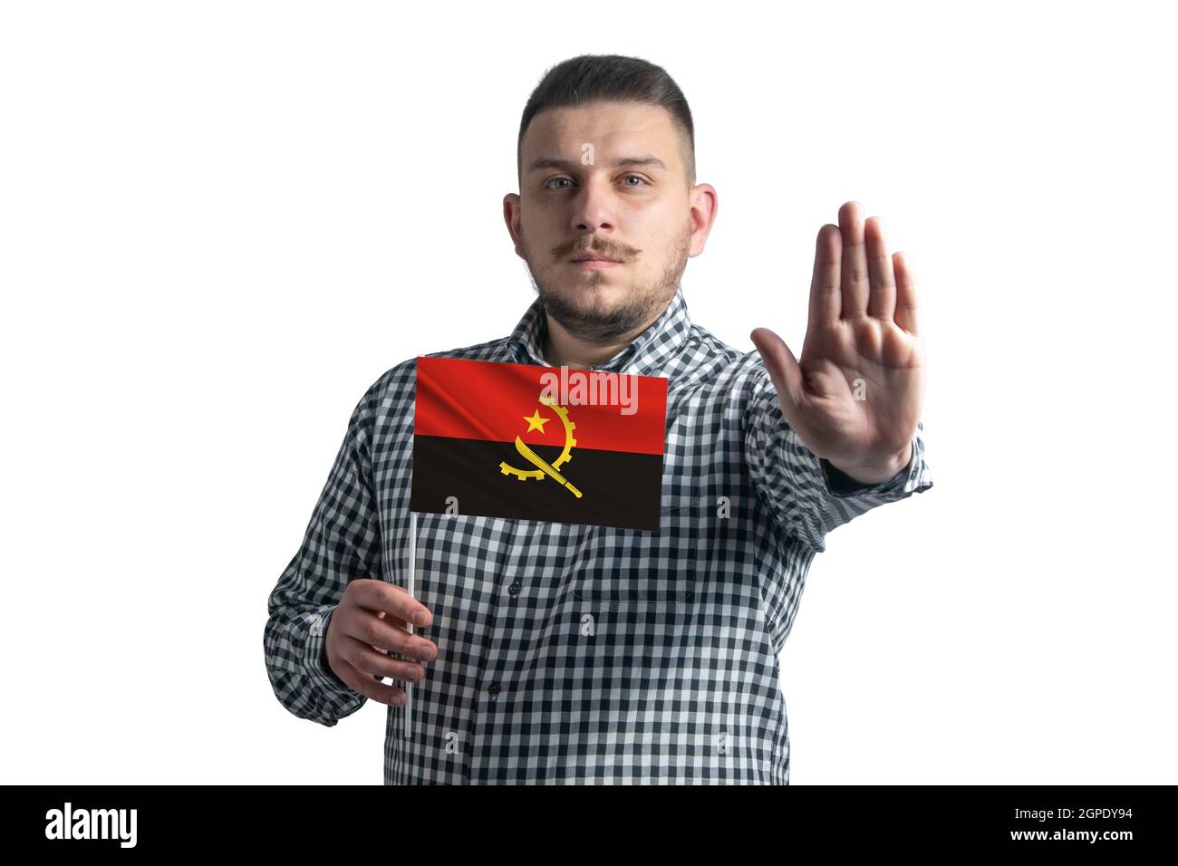 White guy holding a flag of Angola and with a serious face shows a hand ...