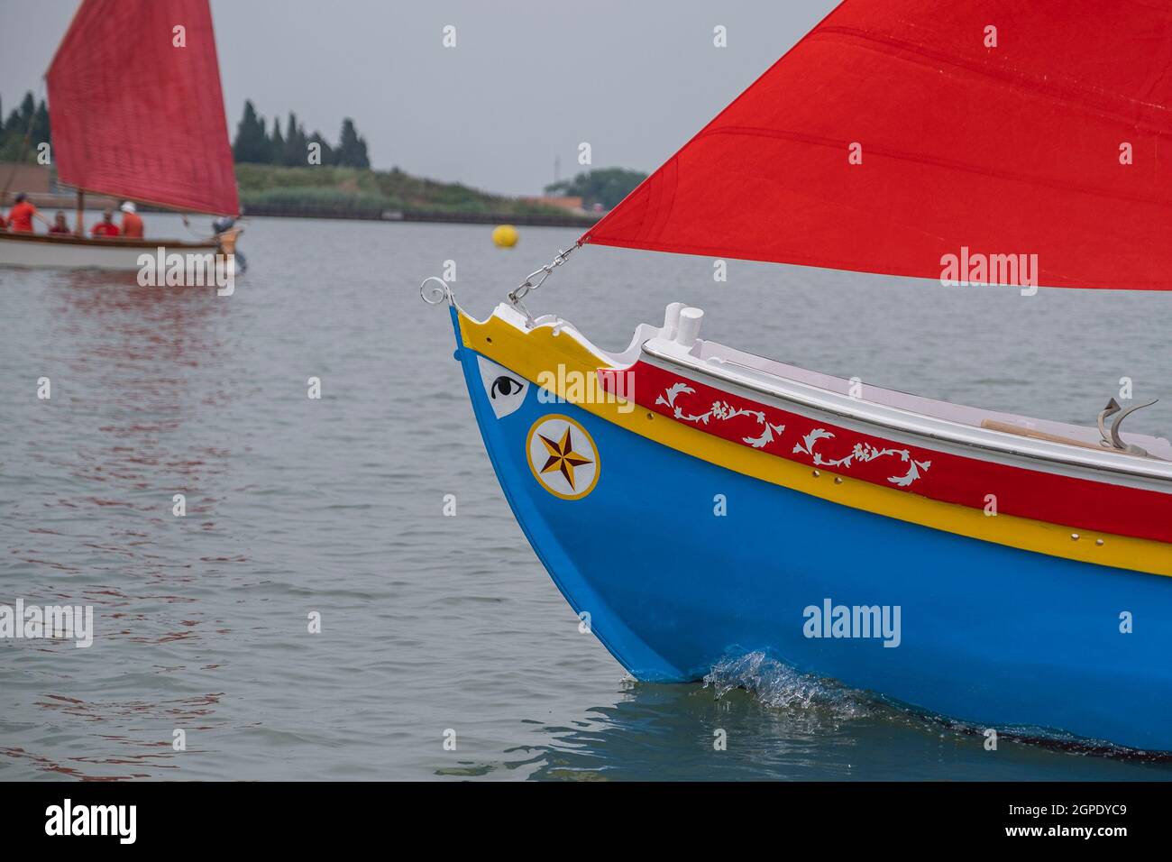 VENICE, ITALY - JUNE 20: Red regatta participants sail in the lagoon ...