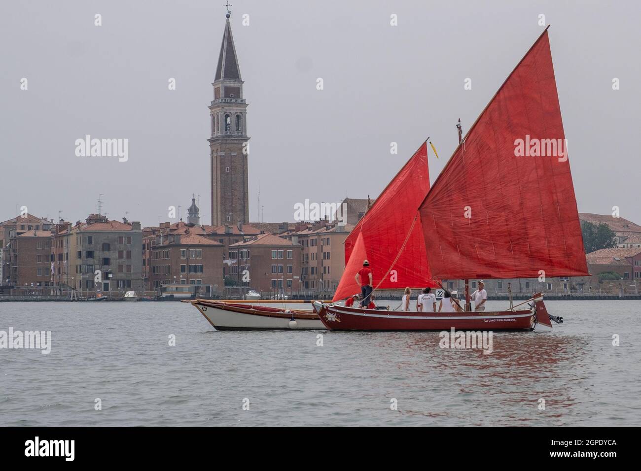 VENICE, ITALY - JUNE 20: Red regatta participants sail in the lagoon ...