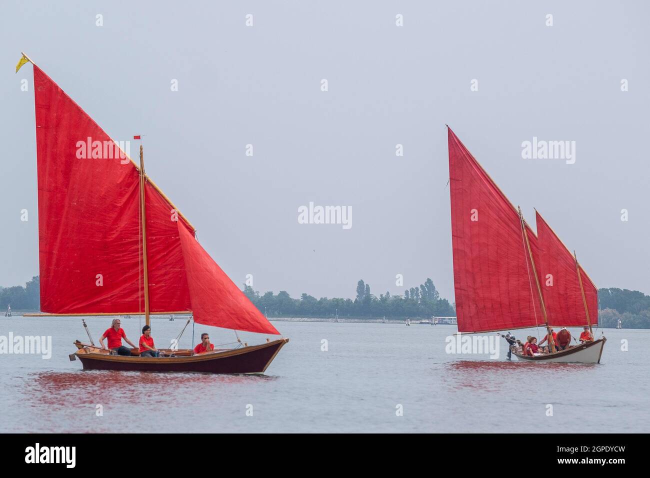 VENICE, ITALY - JUNE 20: Red regatta participants sail in the lagoon ...
