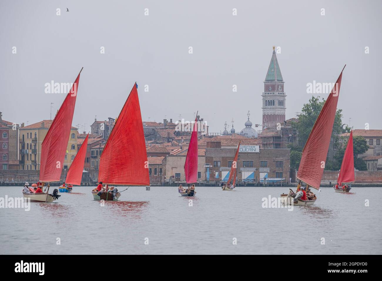 VENICE, ITALY - JUNE 20: Red regatta participants sail in the lagoon ...