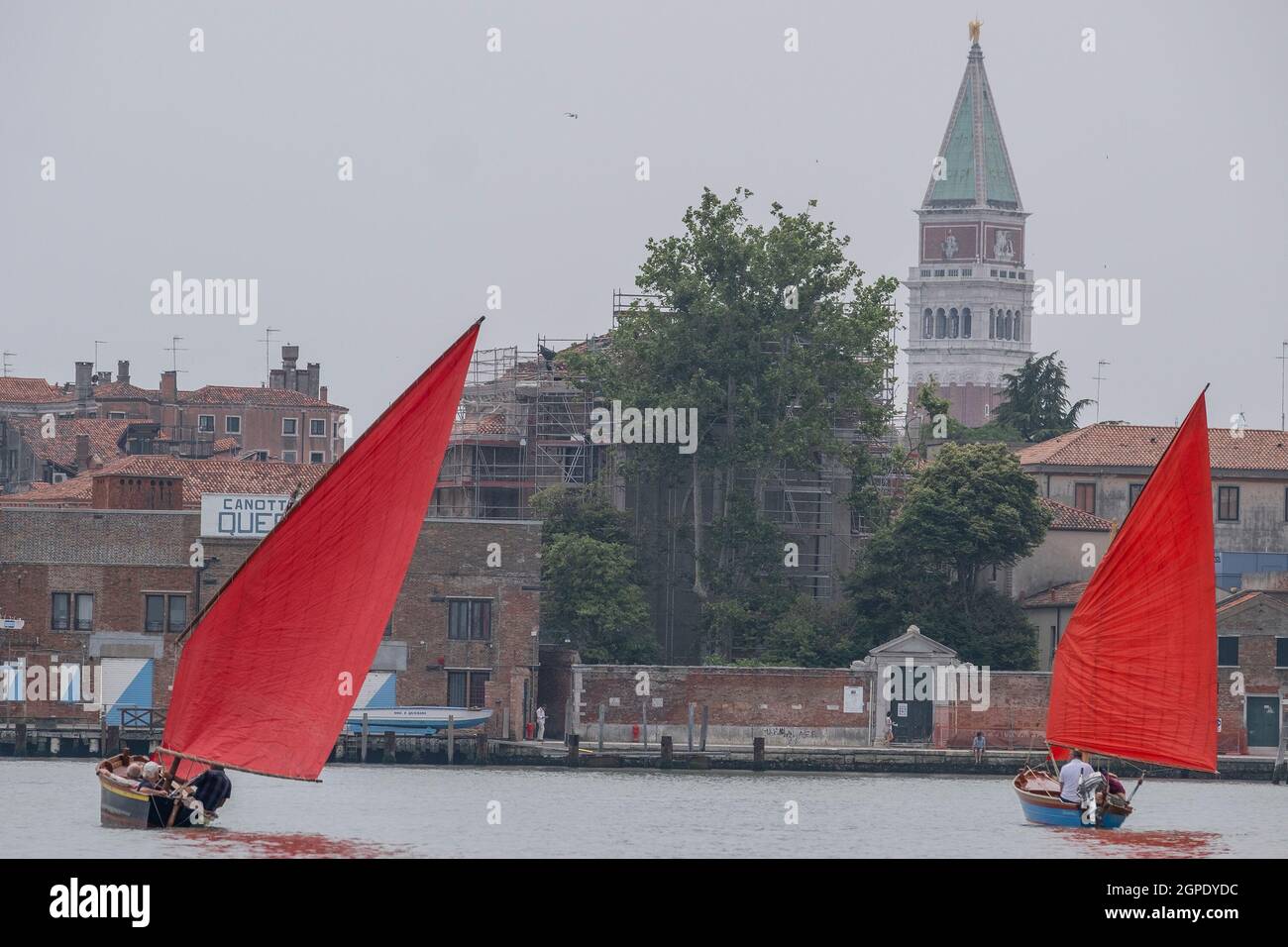 VENICE, ITALY - JUNE 20: Red regatta participants sail in the lagoon ...