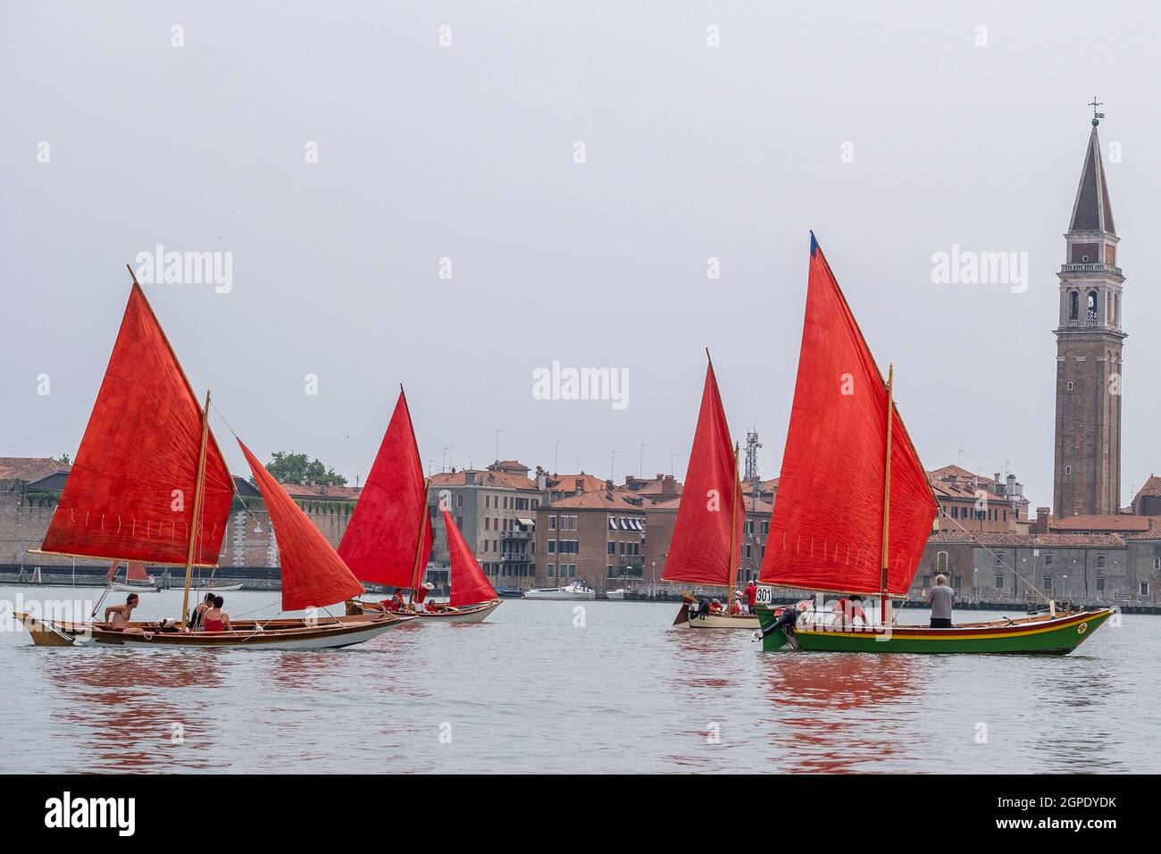 VENICE, ITALY - JUNE 20: Red regatta participants sail in the lagoon ...
