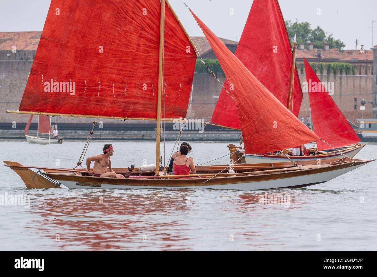 VENICE, ITALY - JUNE 20: Red regatta participants sail in the lagoon ...