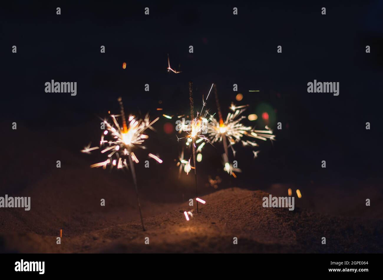 Beach sand at night with Bengal lights. Sparks of bright Bengal Stock ...