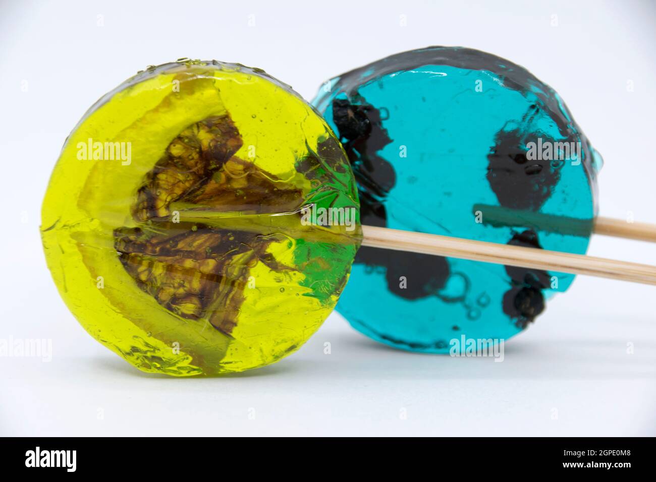 Lollipop with black currant inside turquoise color and lollipop with ...