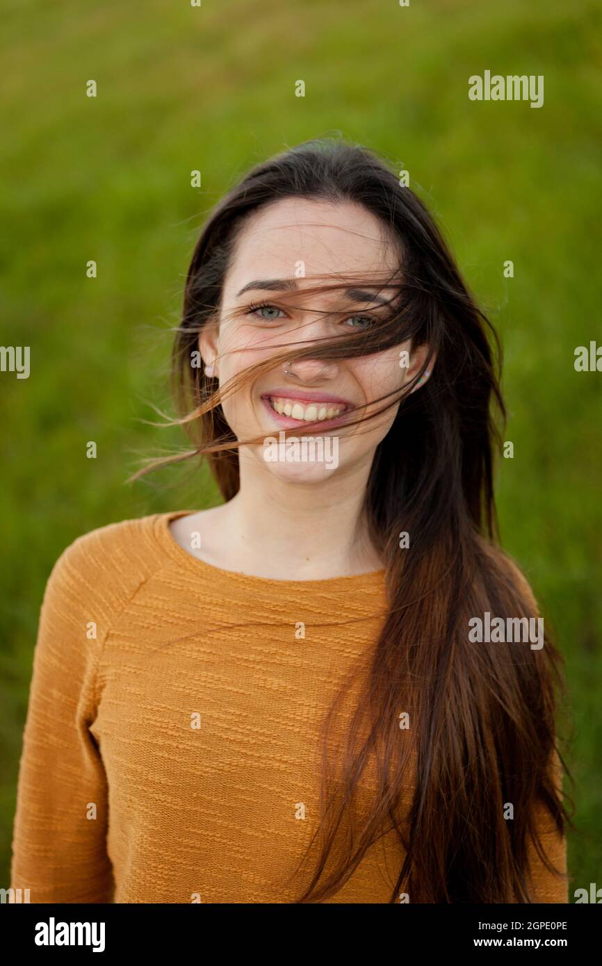 Outdoor portrait of beautiful happy teenager girl laughing while the ...