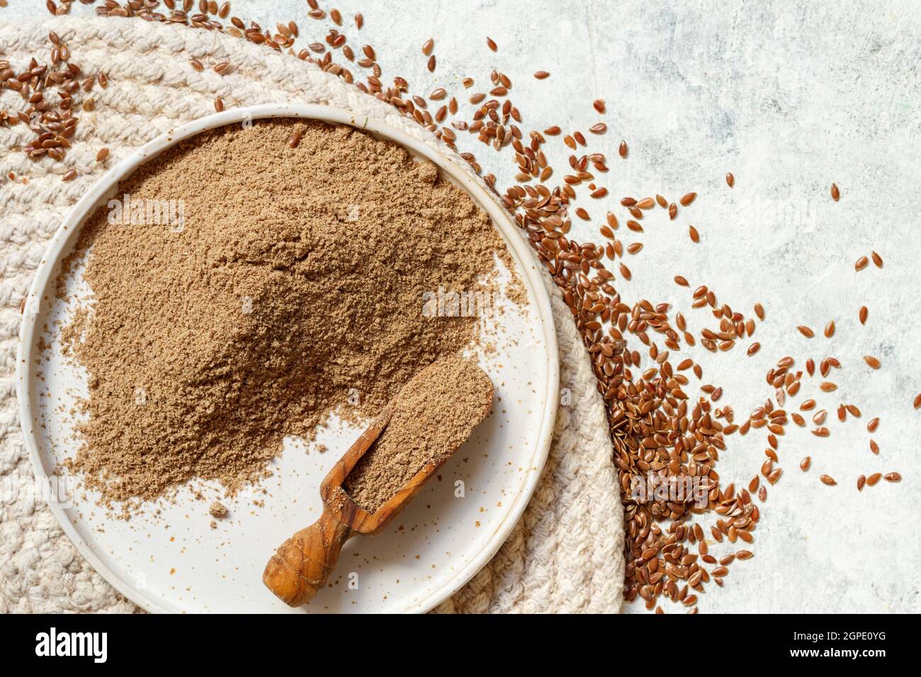 Raw Flax seeds flour in a ceramic plate with a spoon top view Stock ...