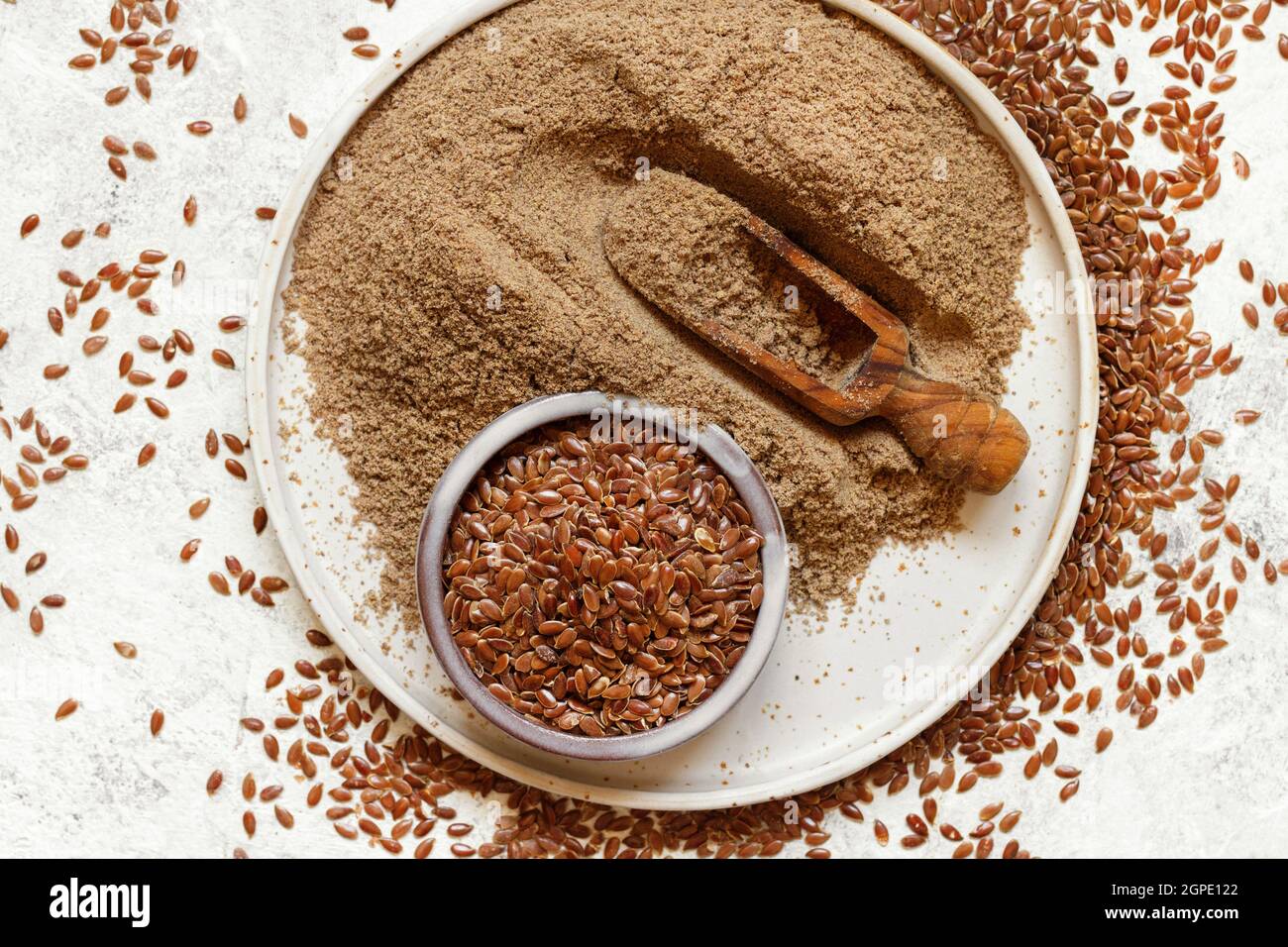 Raw Flax seeds flour in a ceramic plate with a spoon top view Stock ...