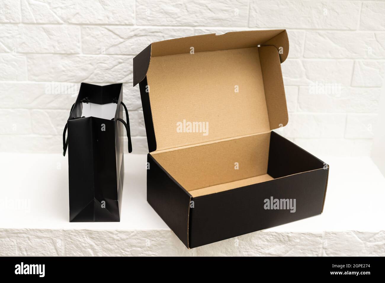 Black cardboard box over white background Stock Photo - Alamy