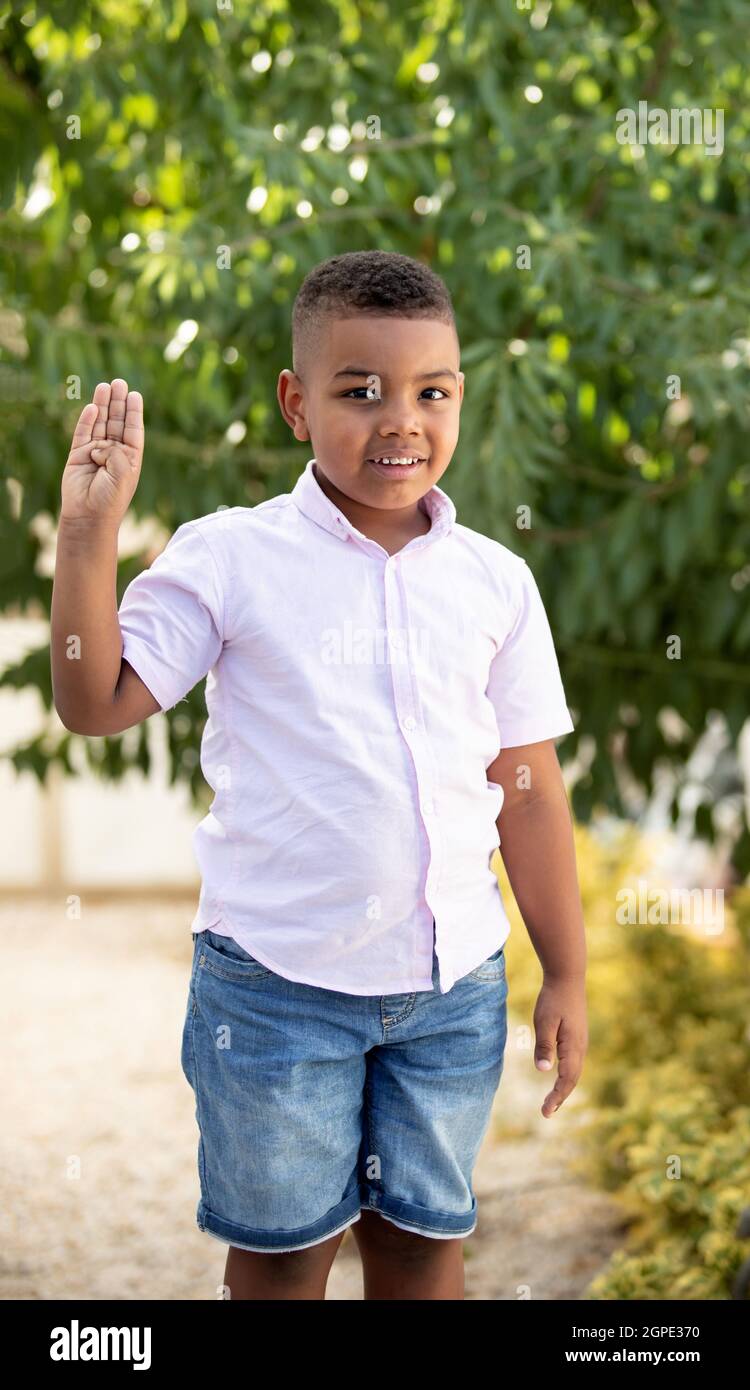Latin child in the garden counting with his fingers Stock Photo - Alamy