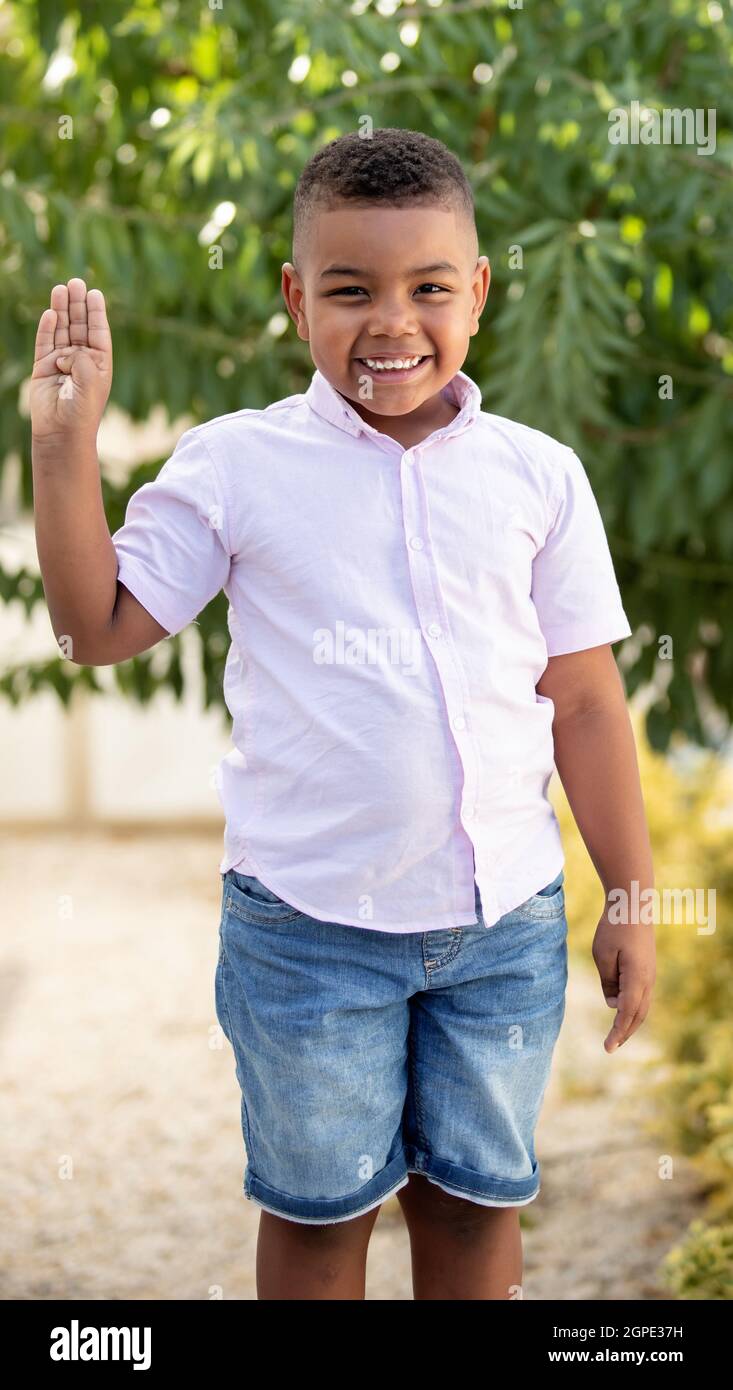 Small latin child counting with his fingers in the garden Stock Photo ...