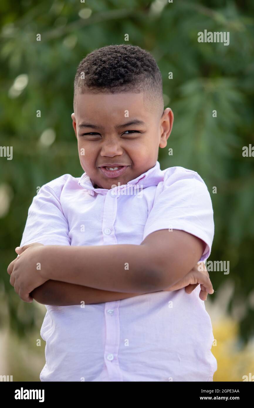 Angry latin child in a day in the park Stock Photo - Alamy