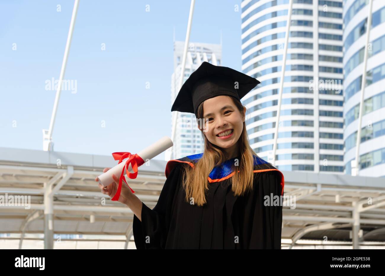 Young woman in graduation dress and cap with happiness smile and ...
