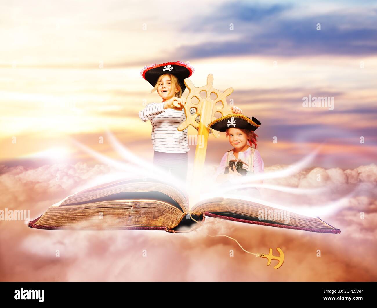 Living the story girls read book about pirates Stock Photo - Alamy