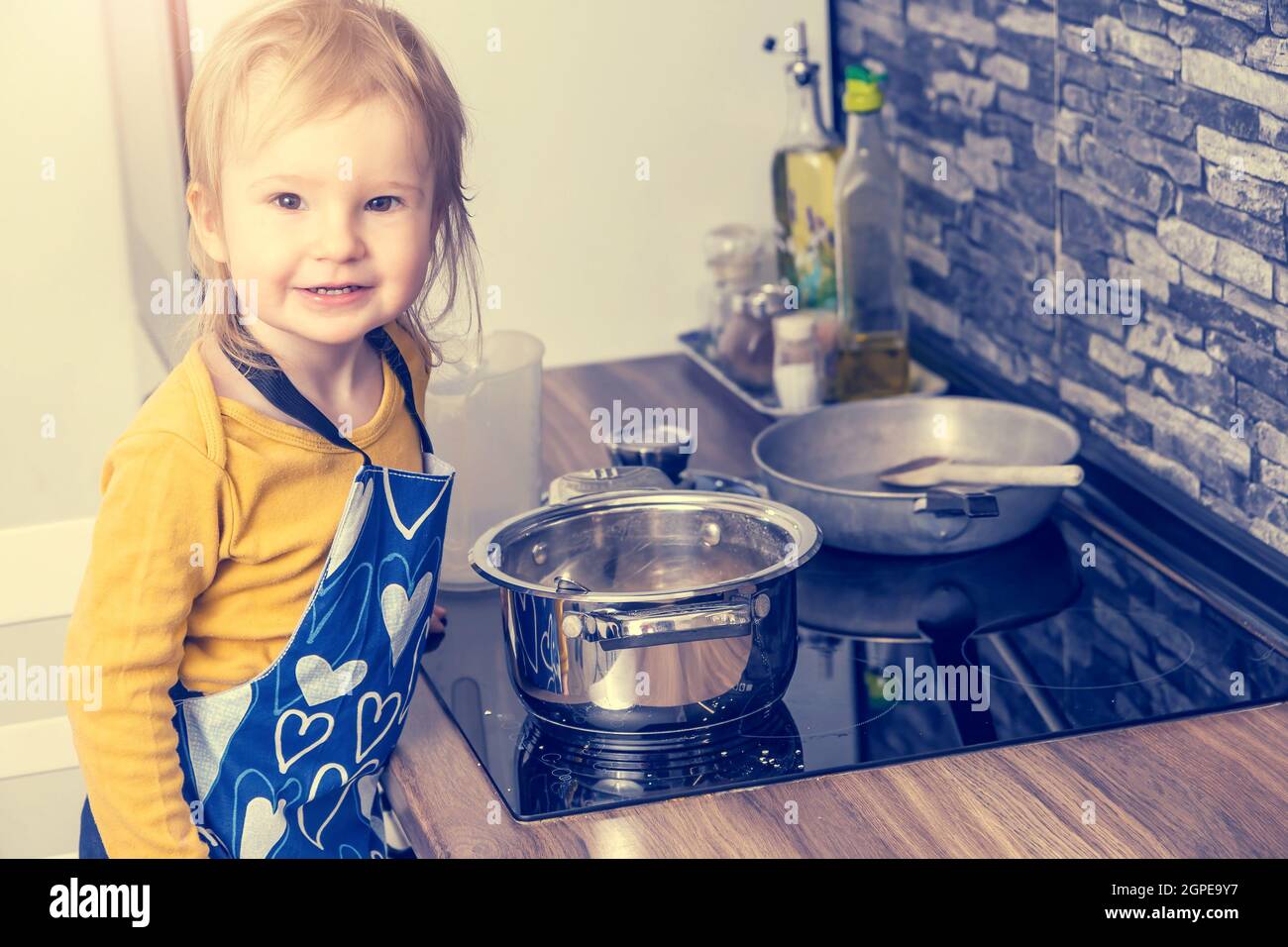 Smiling cute little boy is posing in the kitchen. Horizontally Stock ...