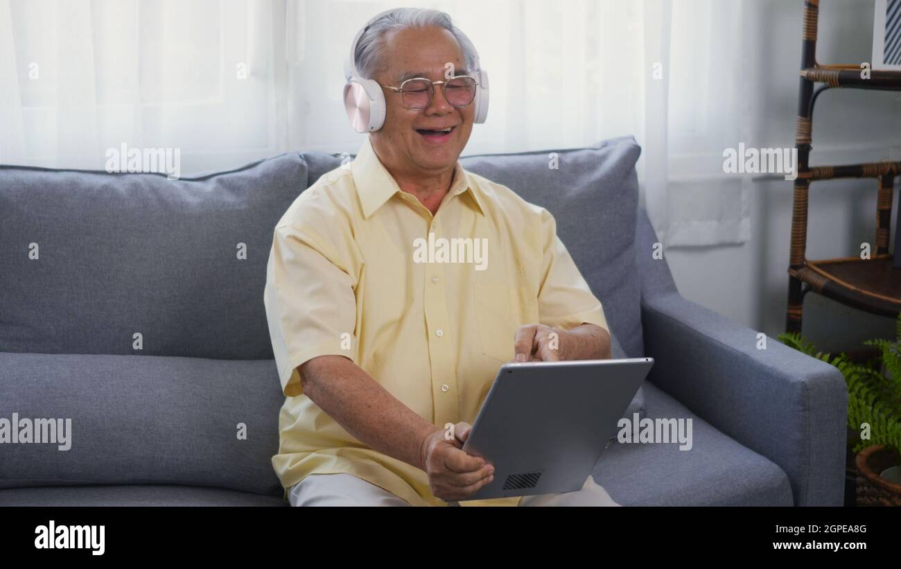 Old man grandfather smile with eyeglasses relaxing wear headphones is ...
