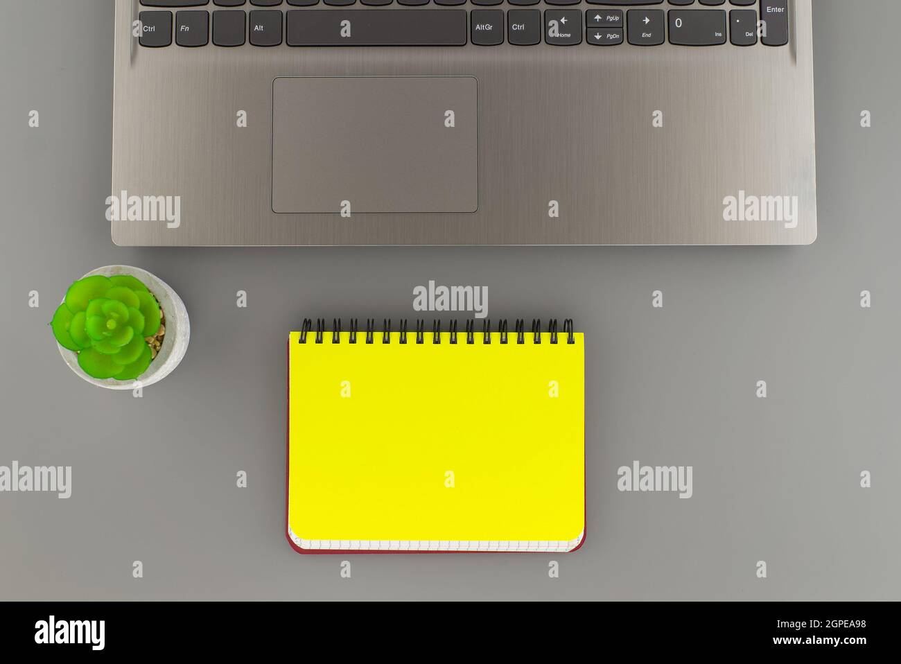 Workplace concept with open laptop and yellow wired blank notebook, view from above Stock Photo ...