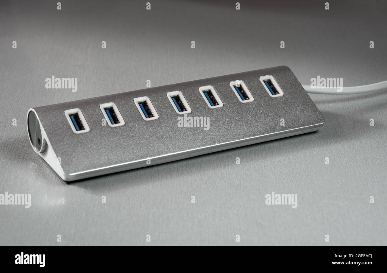 silver usb hub for multiple connections on grey table or workstation ...