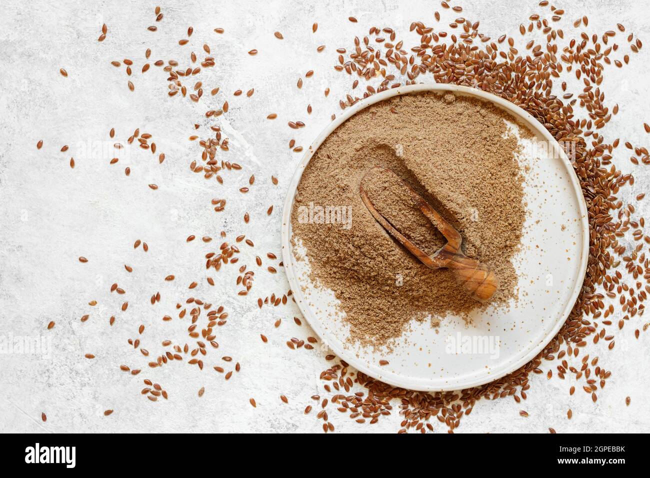 Raw Flax seeds flour in a ceramic plate with a spoon top view Stock ...