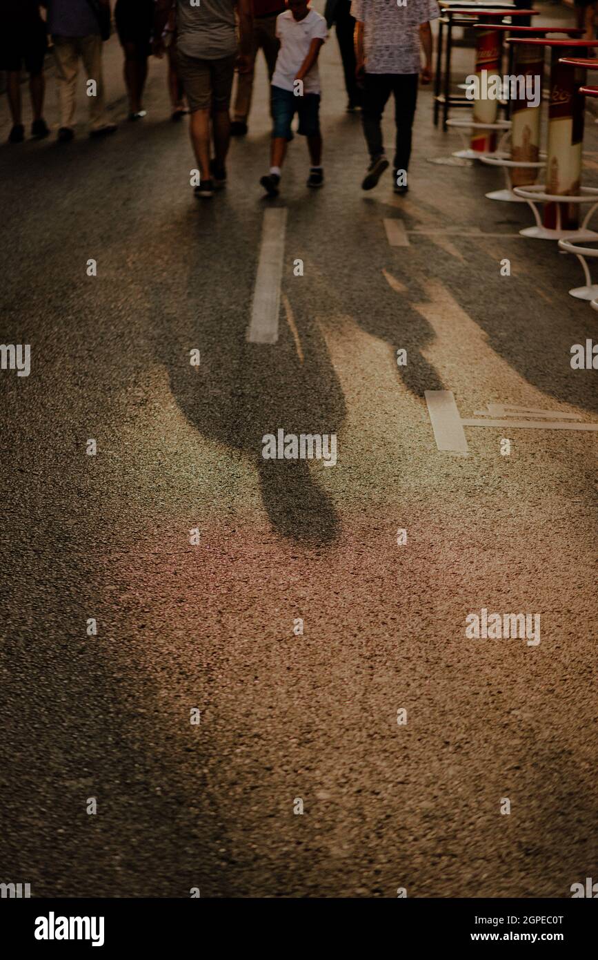 Vertical shot of people's feet walking in the street Stock Photo - Alamy