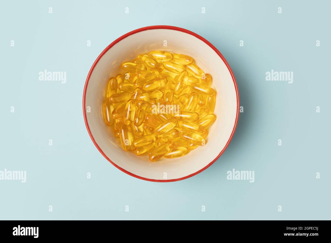 Omega 3. Vitamin E. Omega-3 capsules lying in a bowl on a white ...