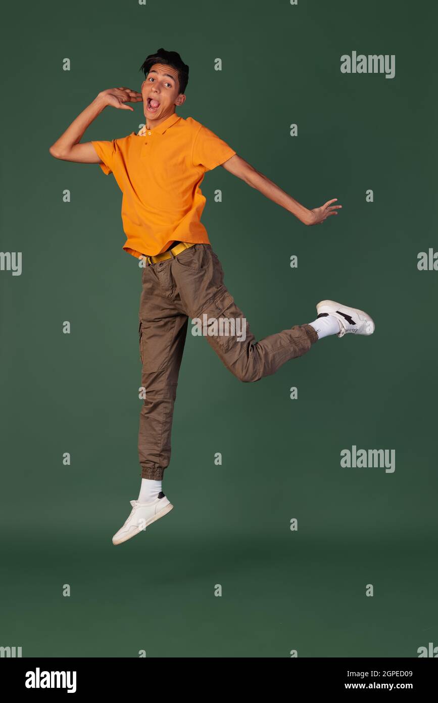 Portrait of young man, student in casual clothes jumping isolated on ...