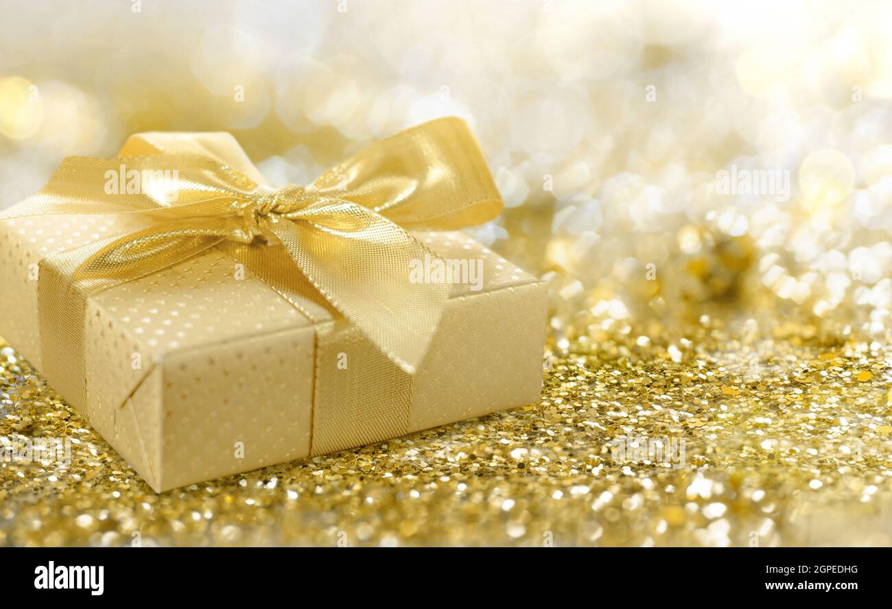 Golden gift box covered with golden foil Stock Photo - Alamy