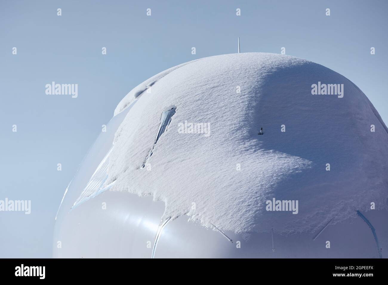 Snow covered cockpit of commercial airplane. Close-up view of plane ...