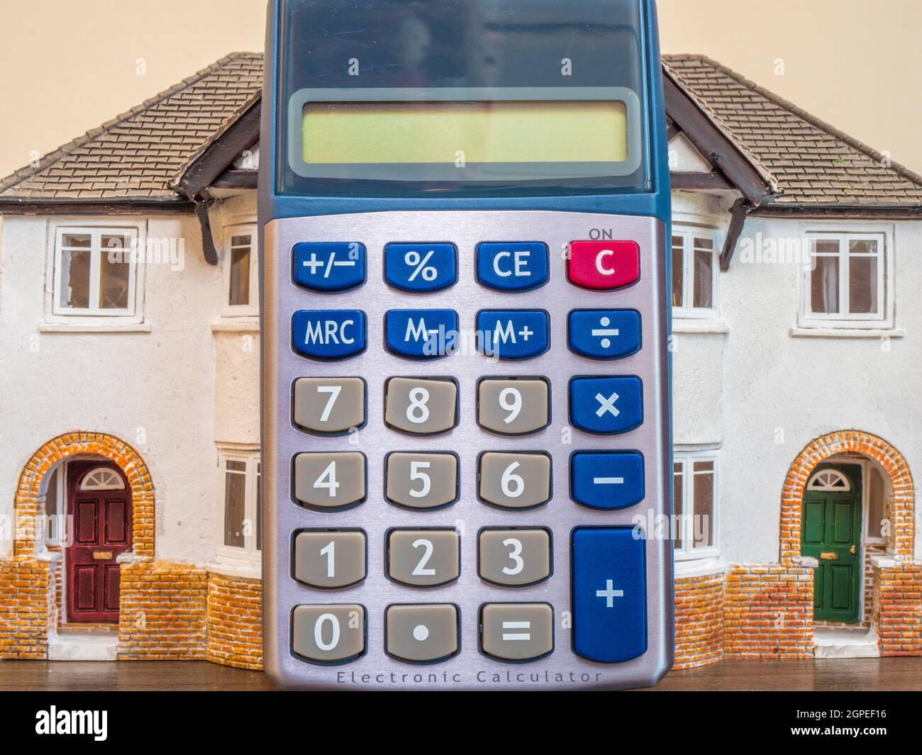 Housing / property market concept: A calculator in front of a model ...