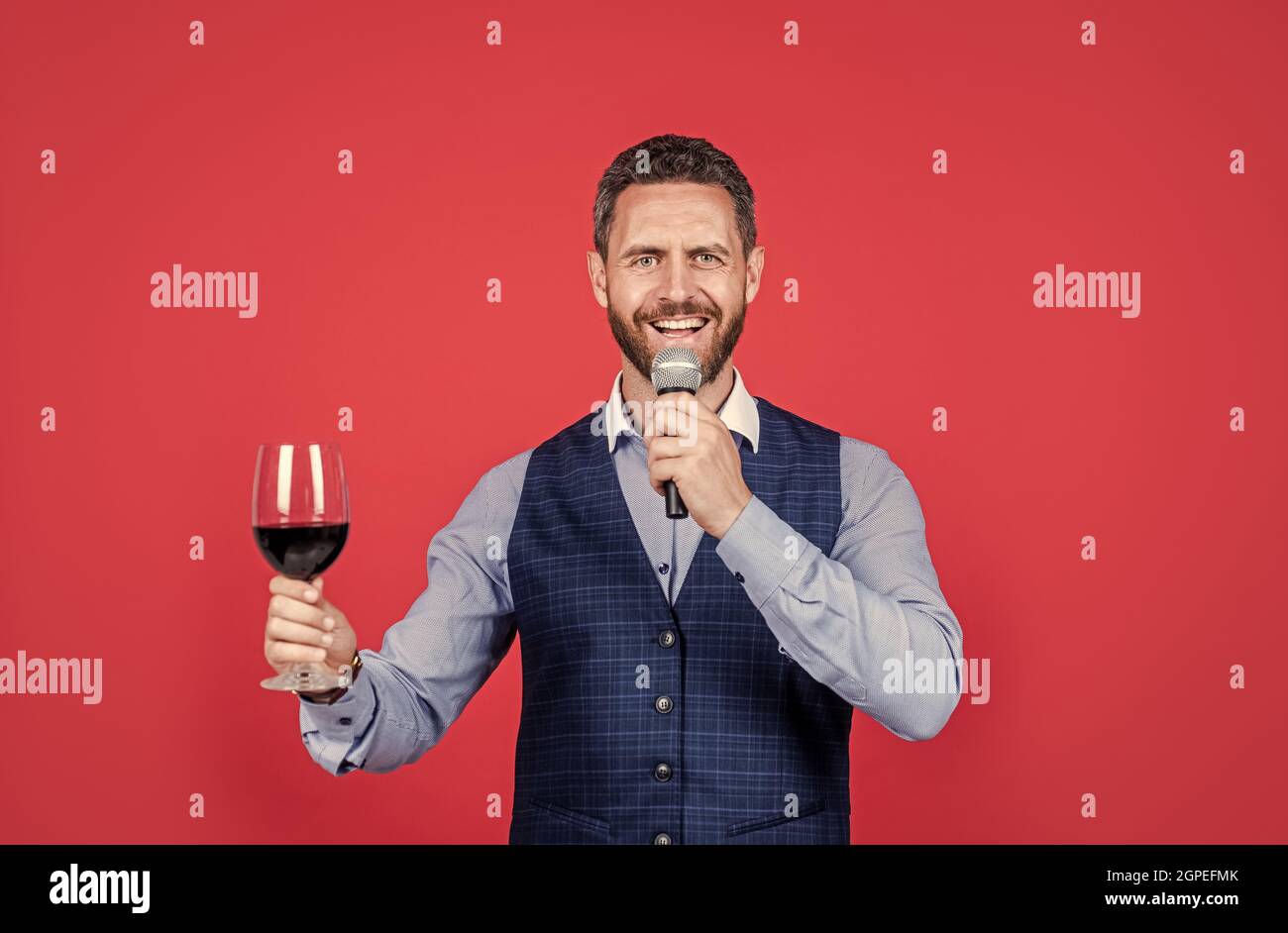 Proposing toast. Toast master speak into microphone lifting glass of ...