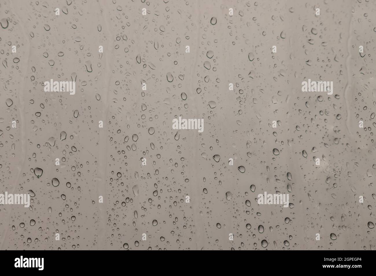 Water rain drops on window glass surface with cloudy background for ...