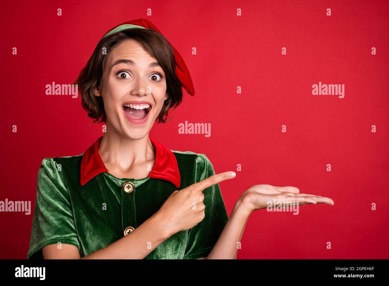 Photo of young excited woman happy positive smile indicate finger ads ...