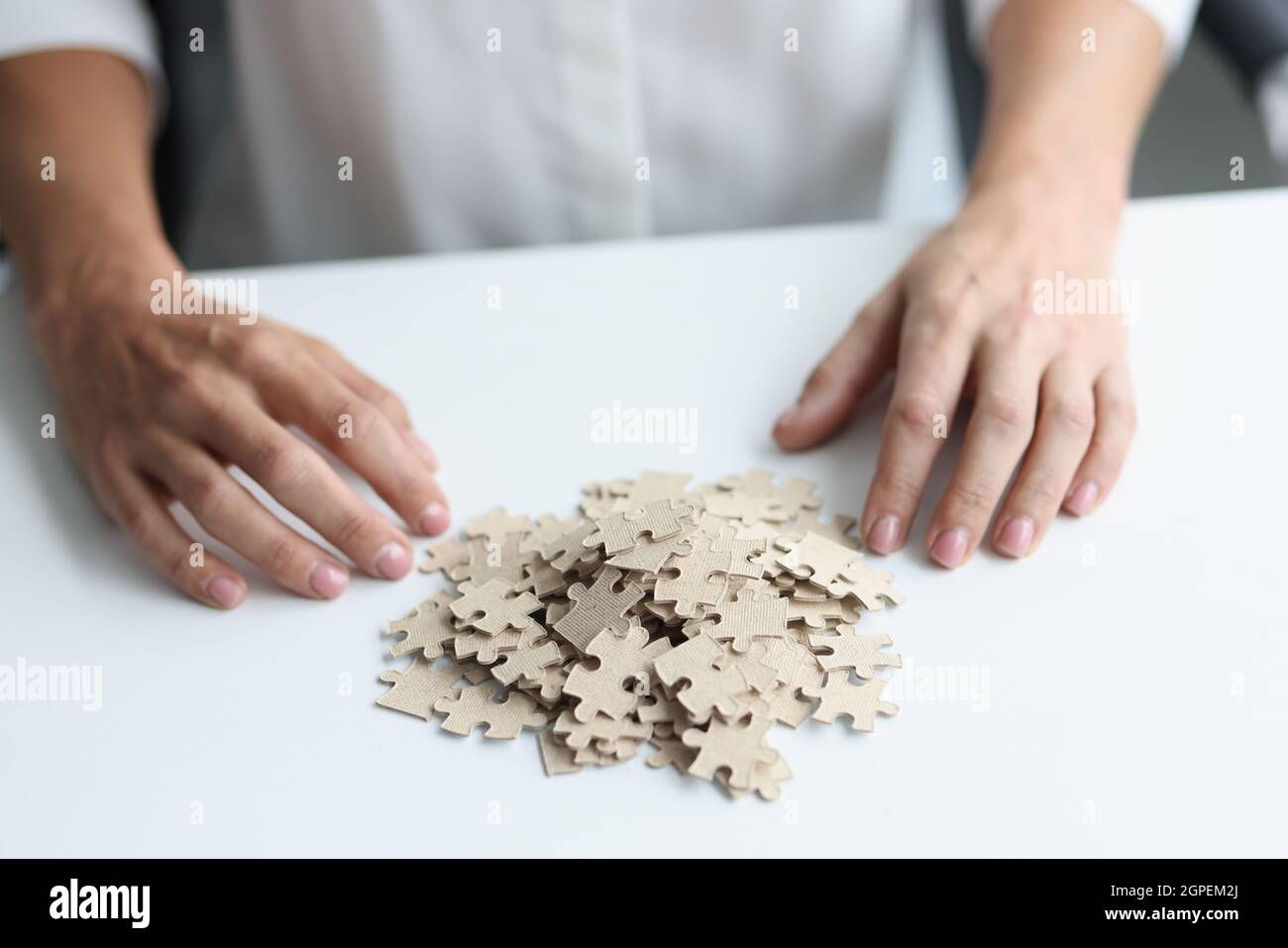 Decomposition of puzzles and female hands on table closeup Stock Photo ...