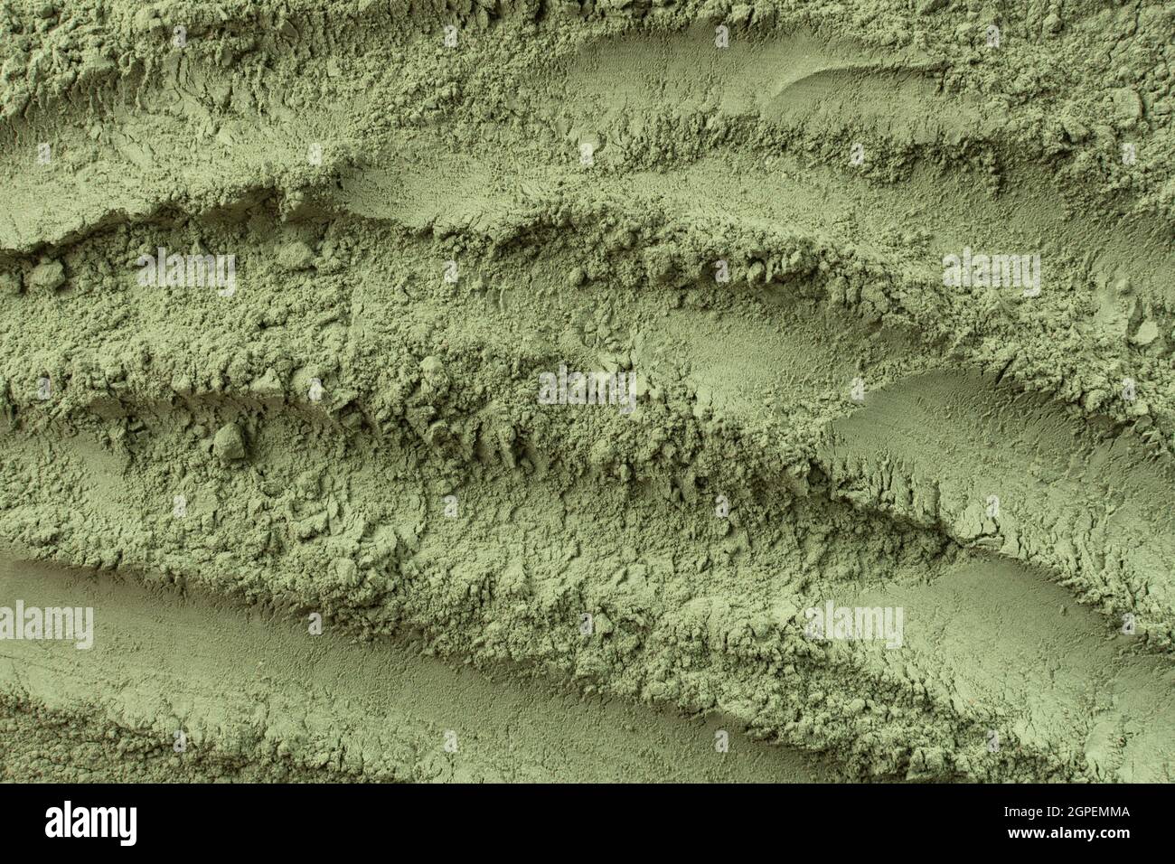 Texture of dry green cosmetic clay with brushstroke top view. Abstract ...
