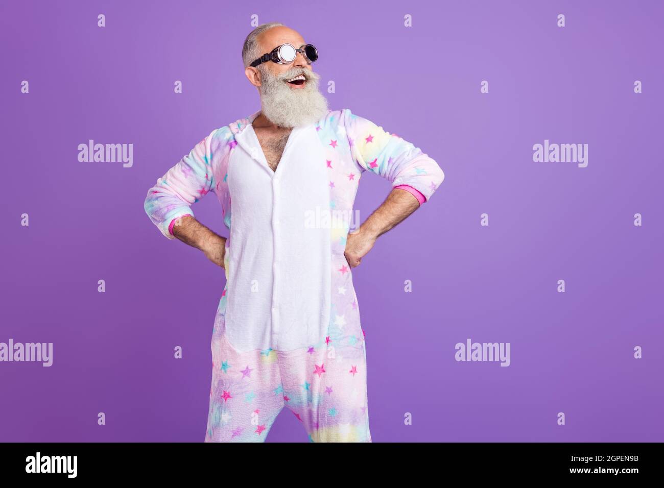 Portrait of attractive cheerful man wearing pajama pilot specs hands on ...
